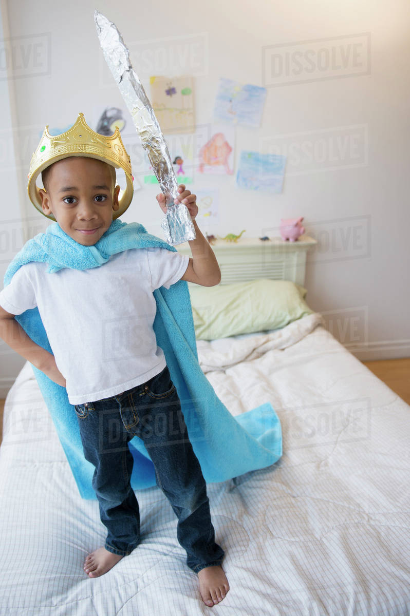 African American boy wearing costume on bed - Royalty-free Stock Photo ...