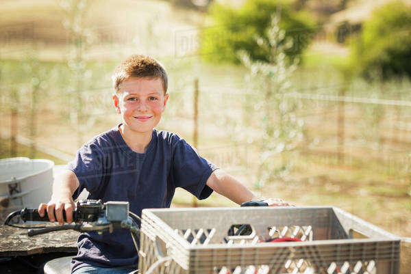 Caucasian boy driving four wheeler outdoors - Stock Photo - Dissolve