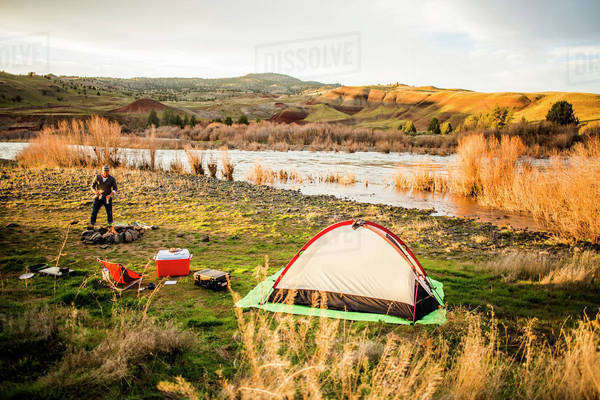 Caucasian man camping near remote river, Painted Hills, Oregon, United ...