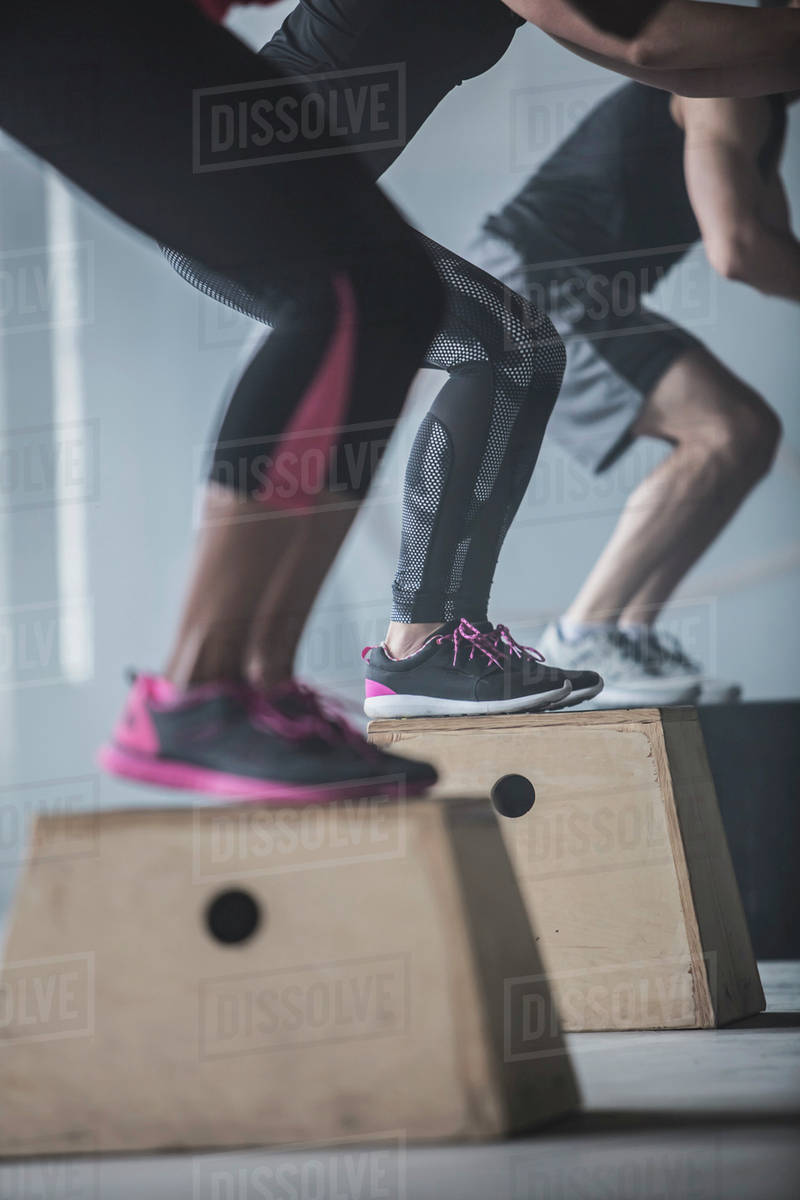 Athletes jumping on platforms in gym - Royalty-free Stock Photo | Dissolve