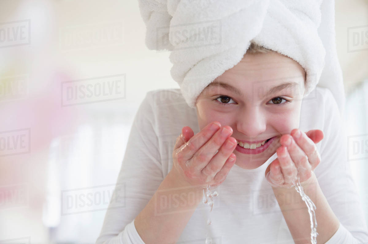Caucasian girl washing face in bathroom - Royalty-free Stock Photo ...