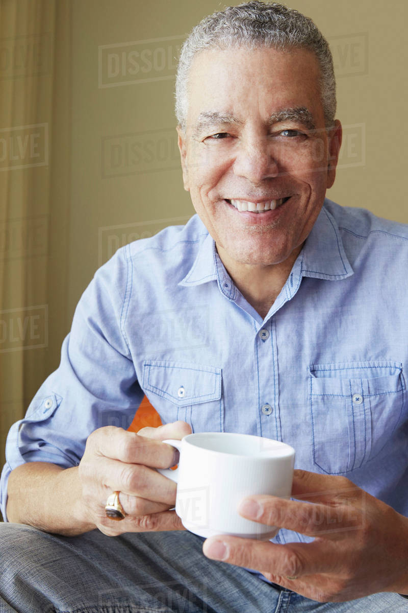 Older Black man drinking coffee - Royalty-free Stock Photo | Dissolve