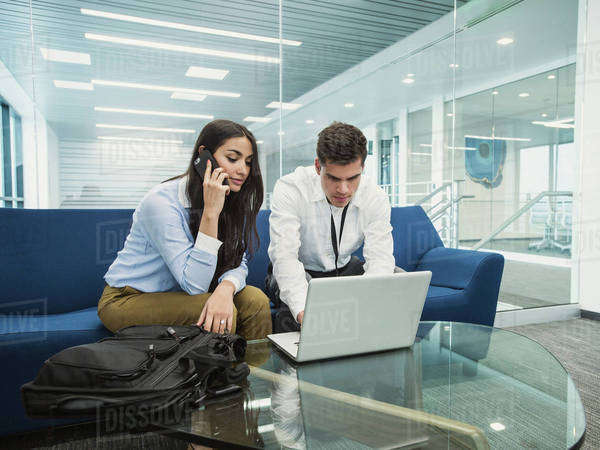 Business people using laptop in office lobby - Royalty-free Stock Photo ...