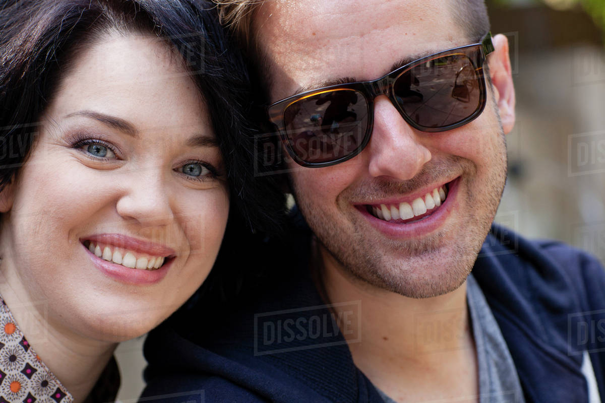 Caucasian couple smiling outdoors - Royalty-free Stock Photo | Dissolve