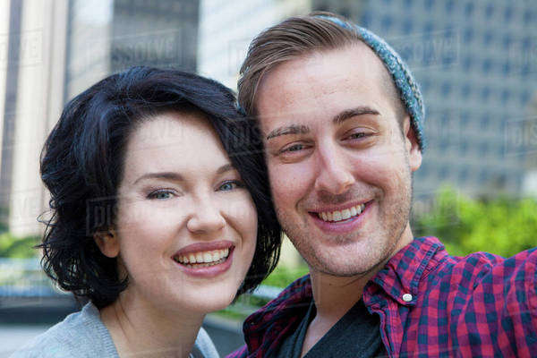 Caucasian couple smiling outdoors - Royalty-free Stock Photo | Dissolve
