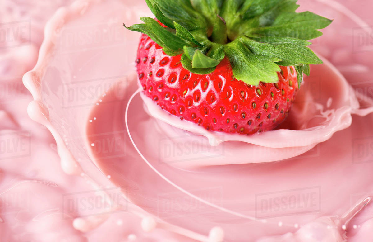 Close up of strawberry splashing in pink liquid - Royalty-free Stock ...