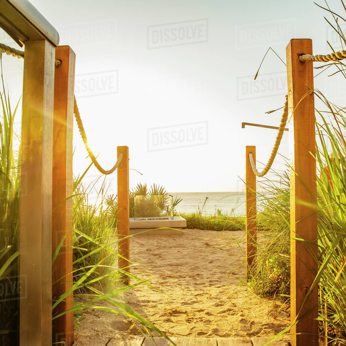 Walkway to beach under blue sky - Royalty-free Stock Photo | Dissolve