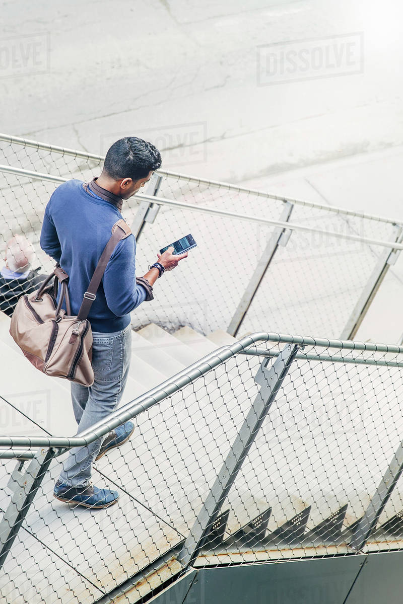 Indian businesswoman using cell phone on steps - Royalty-free Stock ...