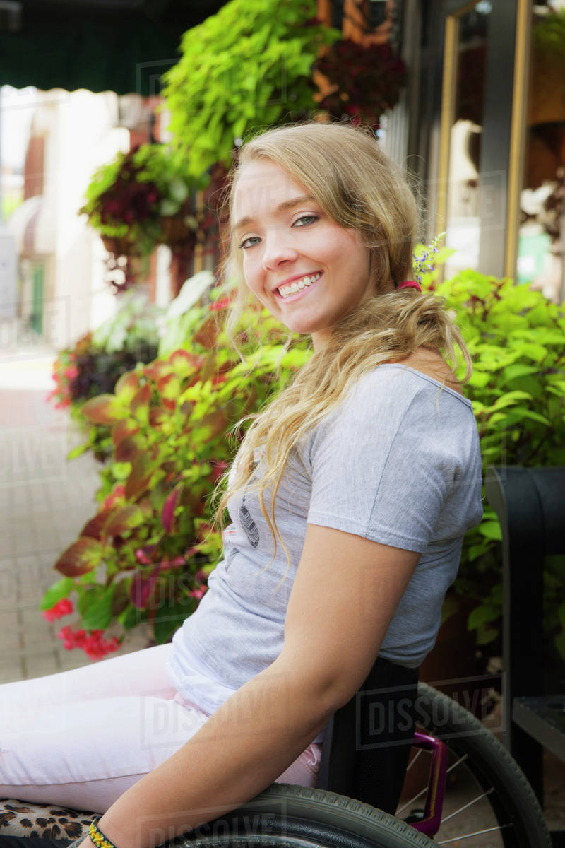 Disabled Caucasian girl smiling in wheelchair - Royalty-free Stock ...
