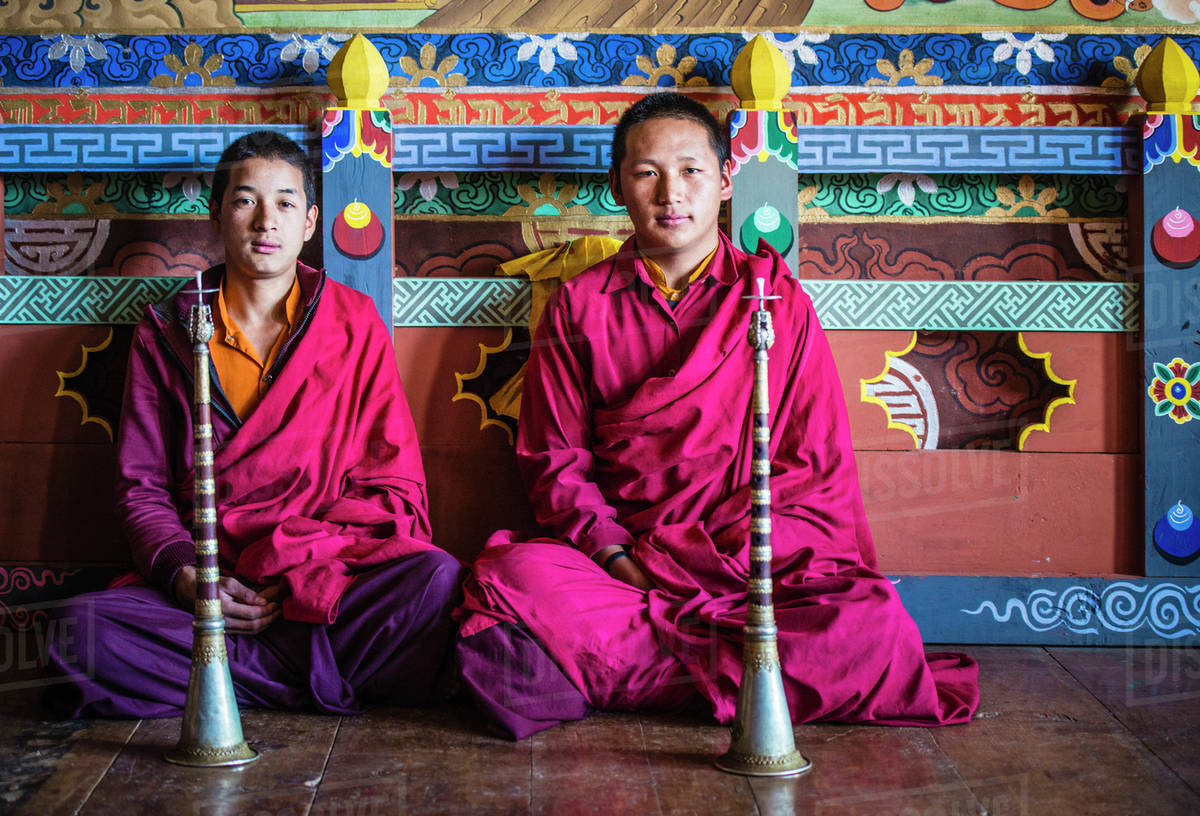 Asian monks sitting on temple floor - Royalty-free Stock Photo | Dissolve