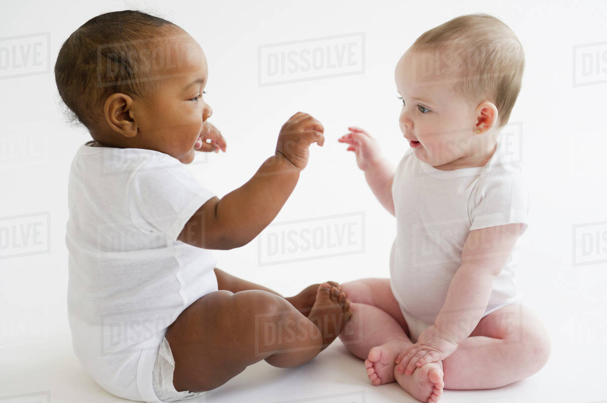 Babies playing together on floor - Royalty-free Stock Photo | Dissolve
