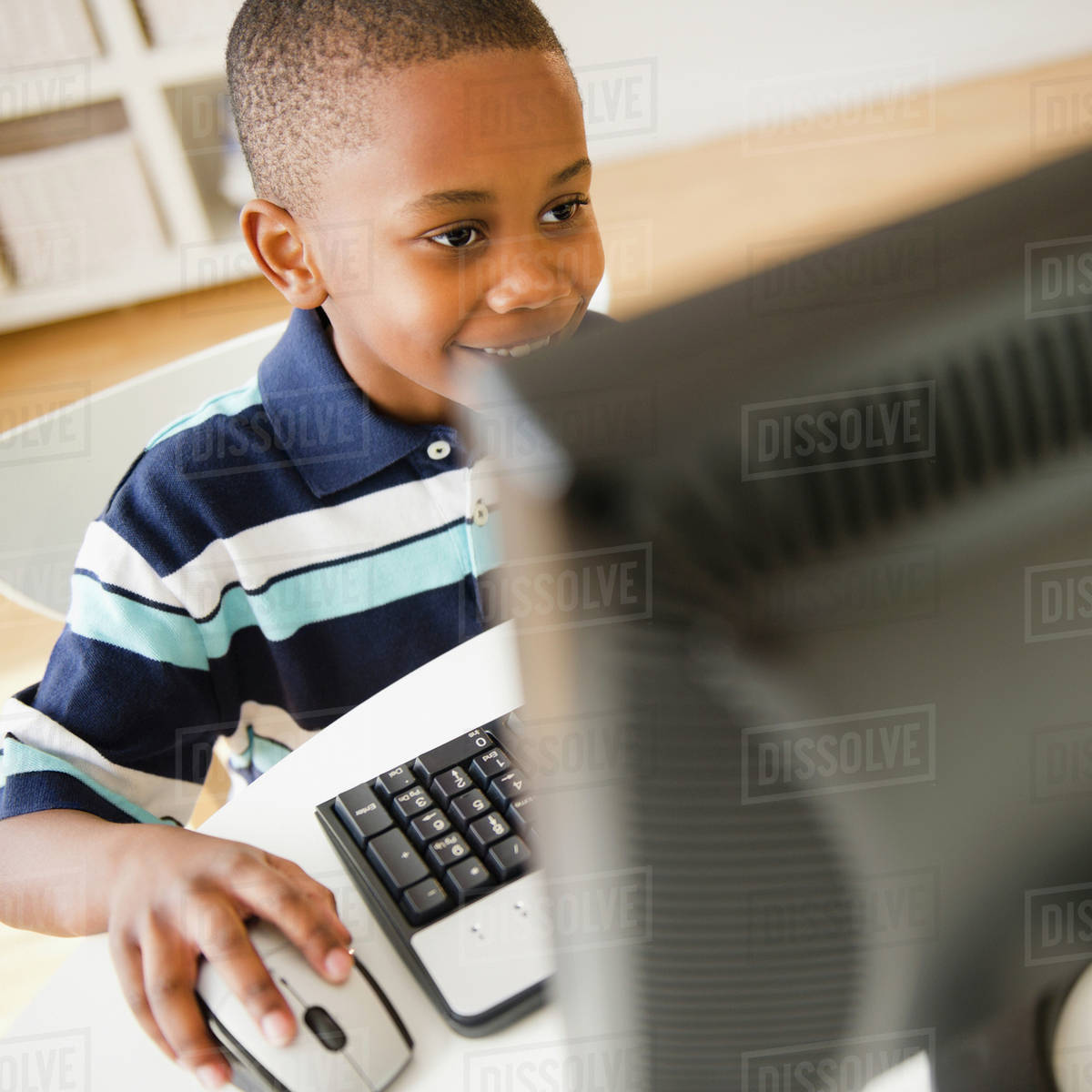 Black boy using computer - Royalty-free Stock Photo | Dissolve