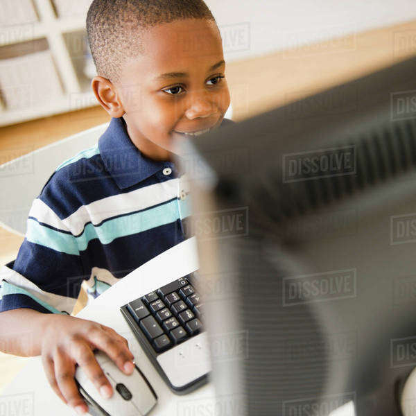 Black boy using computer - Royalty-free Stock Photo | Dissolve