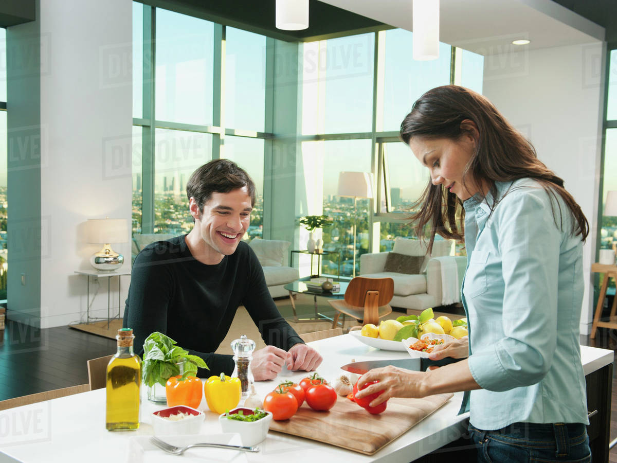 Couple making dinner together in kitchen - Stock Photo - Dissolve