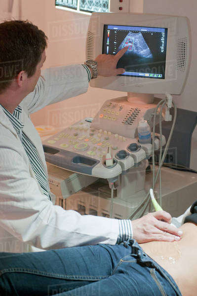 Doctor giving woman a sonogram examination - Stock Photo - Dissolve