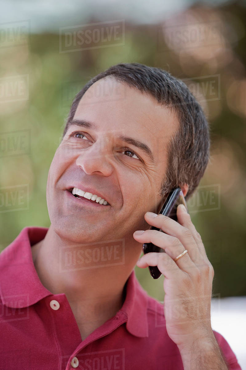 Hispanic man talking on cell phone - Royalty-free Stock Photo | Dissolve