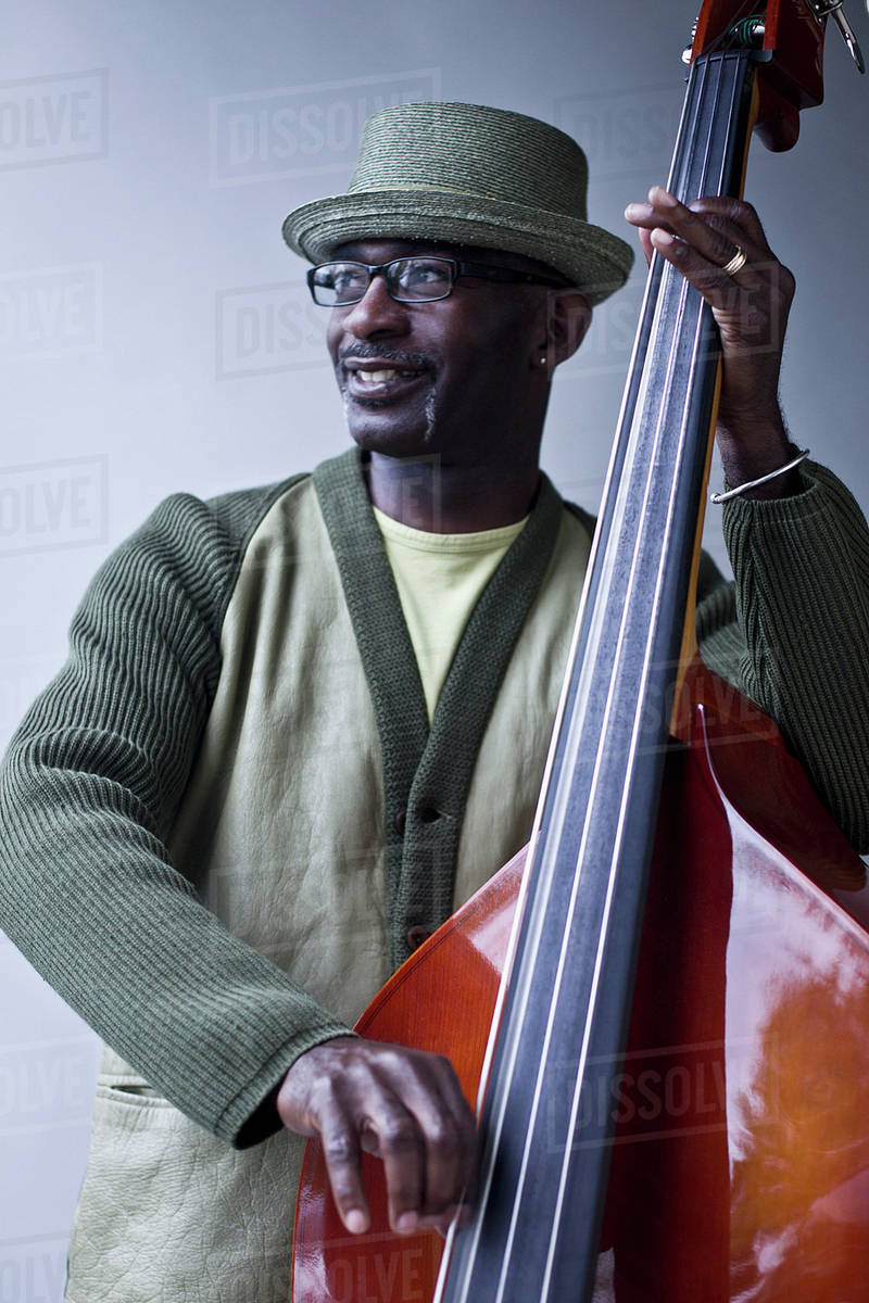 Black musician playing double bass - Stock Photo - Dissolve