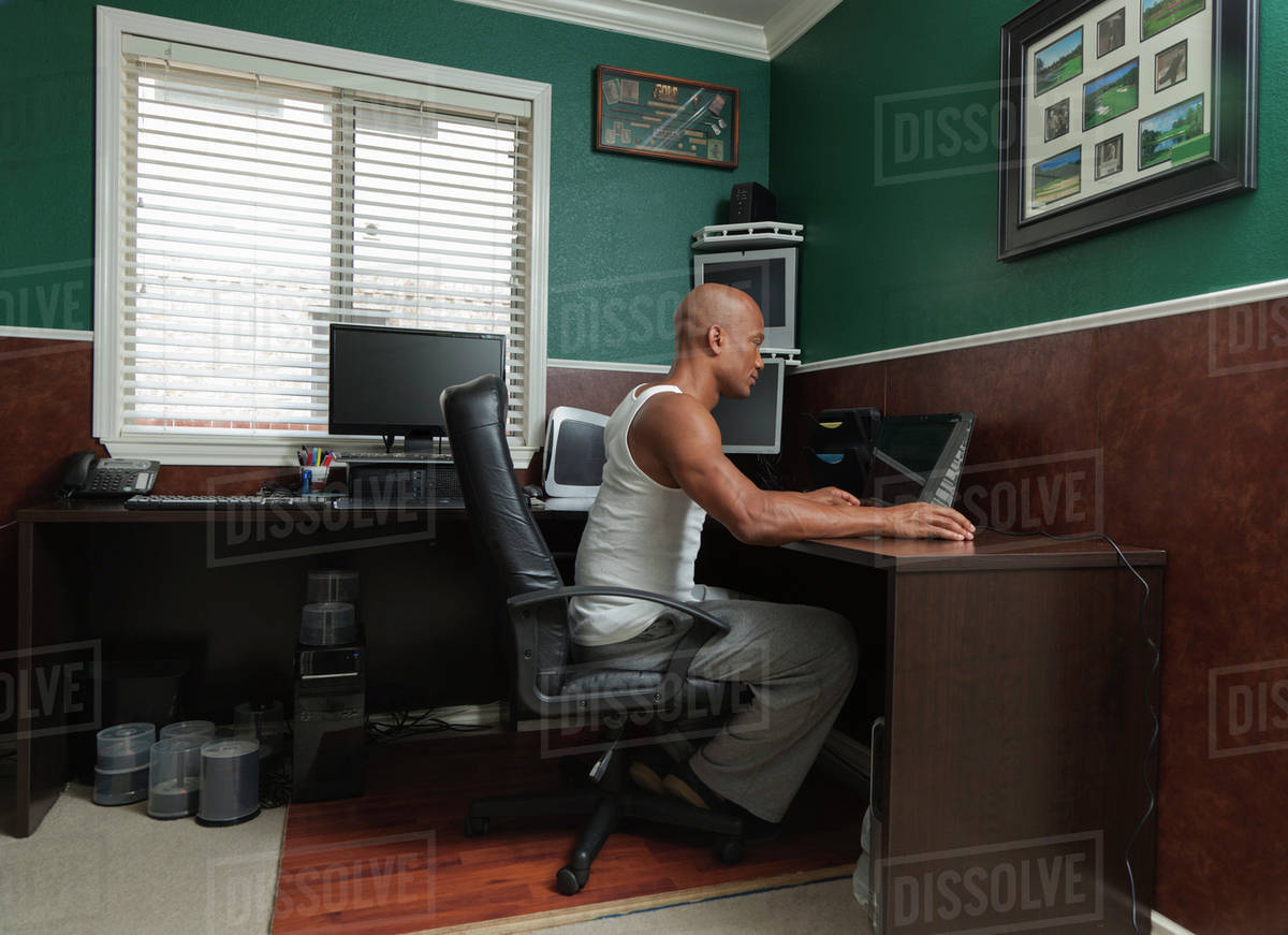 Black man working at desk in home office - Royalty-free Stock Photo ...