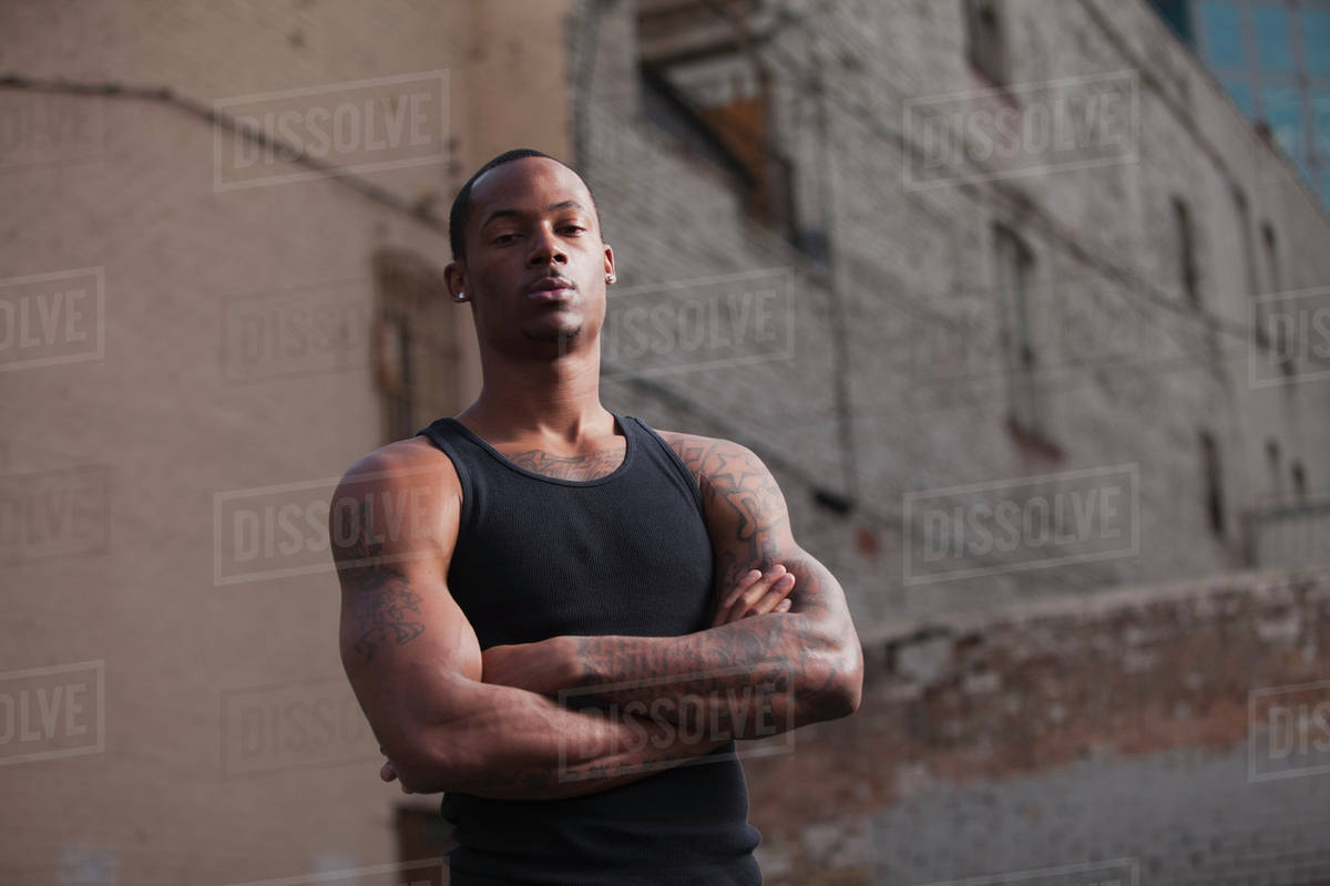 Serious Black man standing outdoors with arms crossed - Stock Photo ...