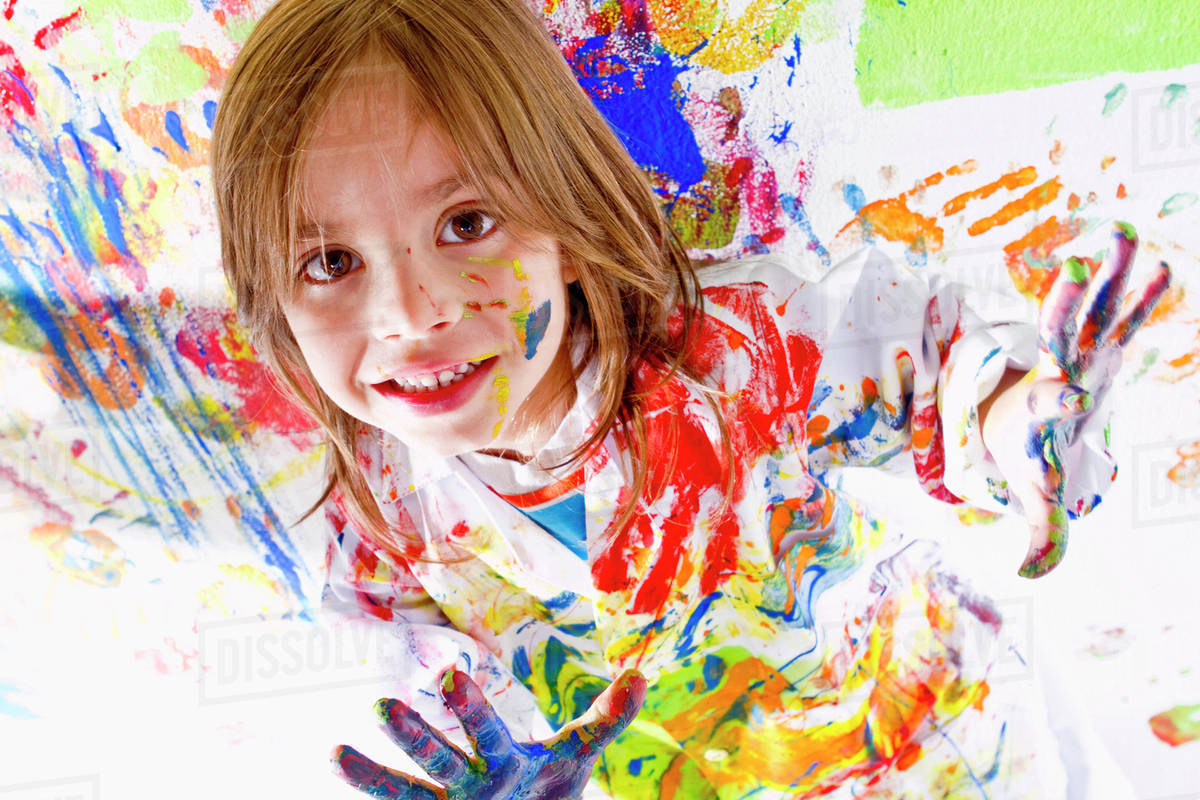Messy Hispanic girl finger painting - Royalty-free Stock Photo | Dissolve