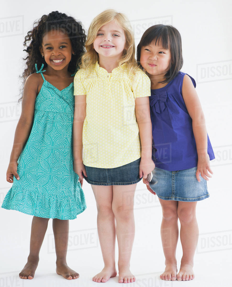 Smiling girls standing together - Royalty-free Stock Photo | Dissolve