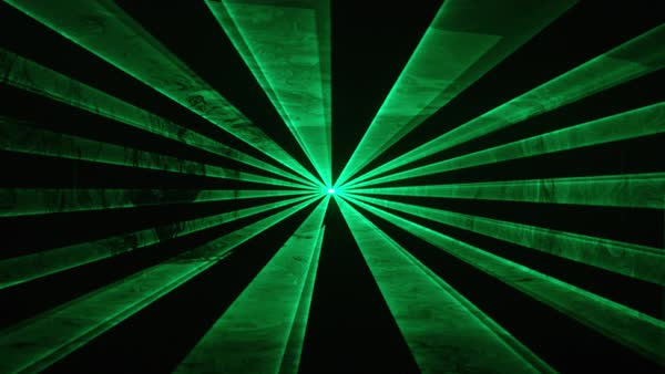 Wide green laser beams shine and rapidly rotate at an empty nightclub ...