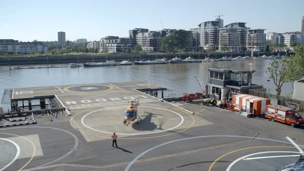 Helicopter starting engine and preparing to take off at the helipad ...