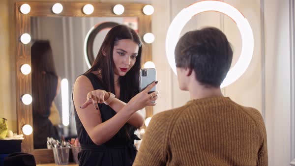 Make up artist taking photos of male model before the make up - 4K ...