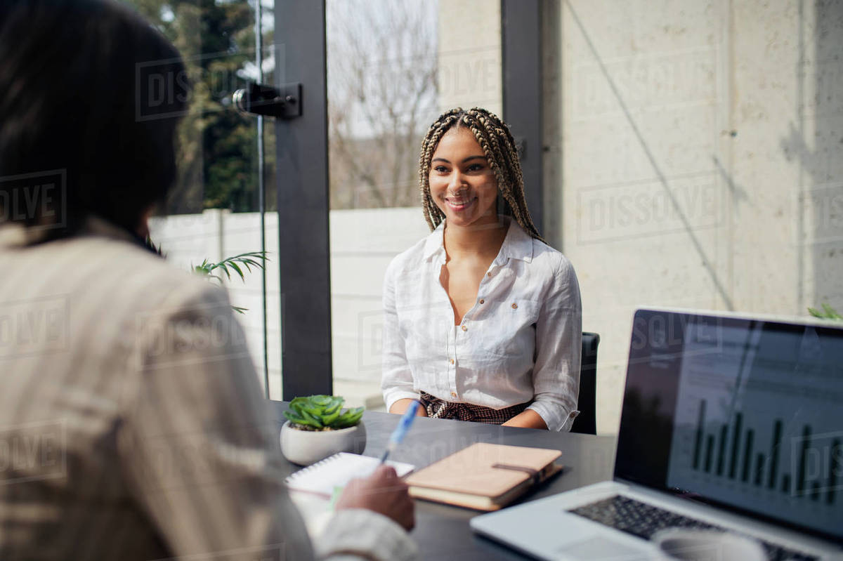 A happy young woman having job interview in office, business and career ...