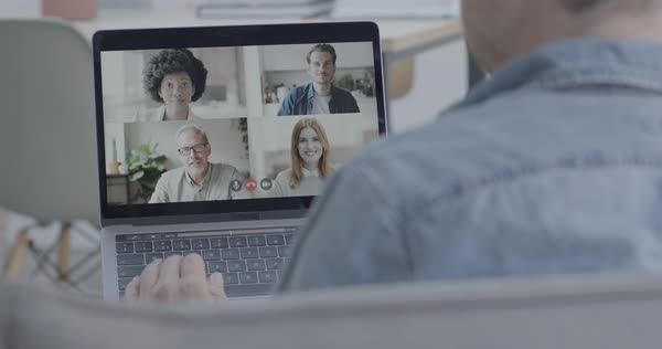 Business man having Video call with colleagues on laptop from home ...