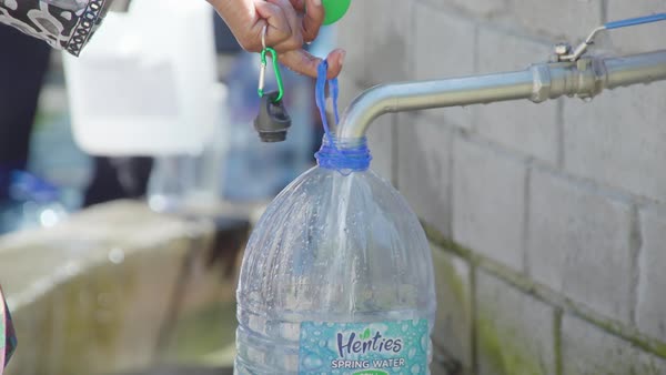 People collecting water from a public spring during the 2018 water ...