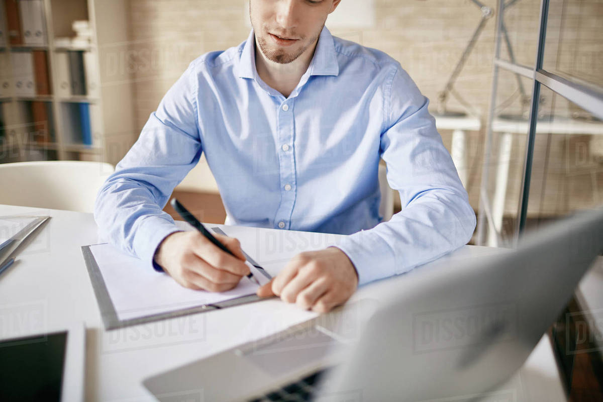 Office worker filling document at the table - Royalty-free Stock Photo ...