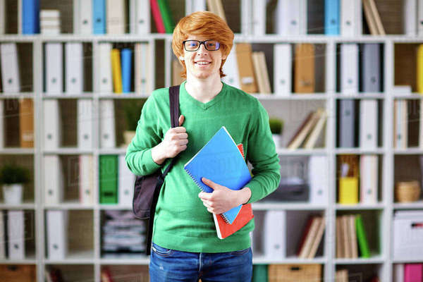 Portrait of smart and confident student smiling at camera - Royalty ...