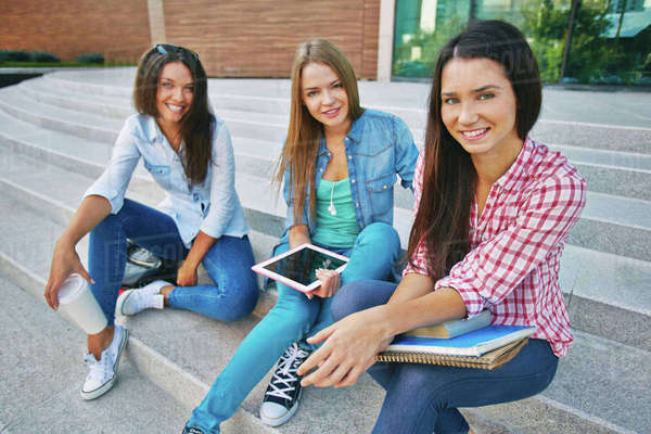 Portrait of three students sitting outdoors in break - Royalty-free ...