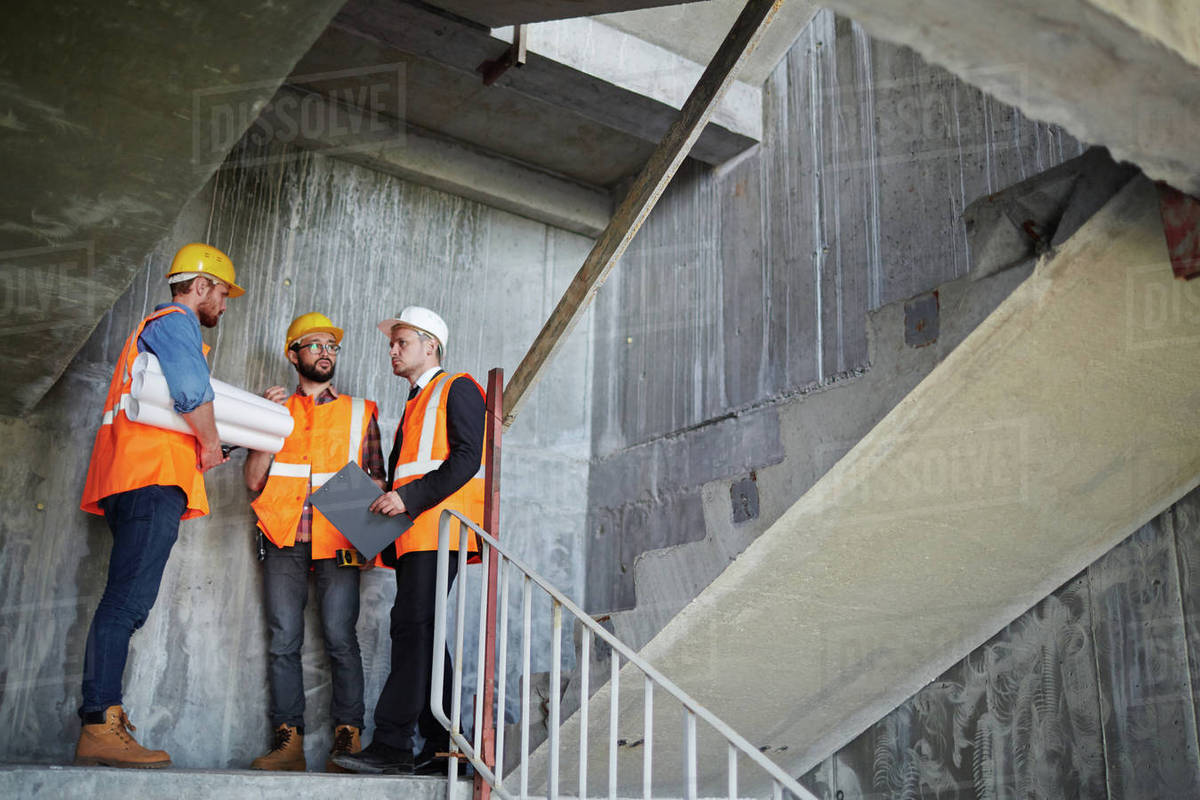 Group of inspectors discussing quality of newly done work - Royalty ...