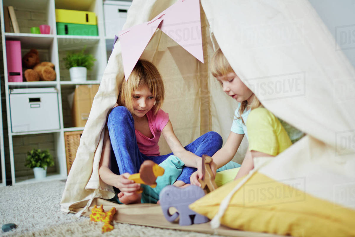 Two girls playing together at home - Royalty-free Stock Photo | Dissolve