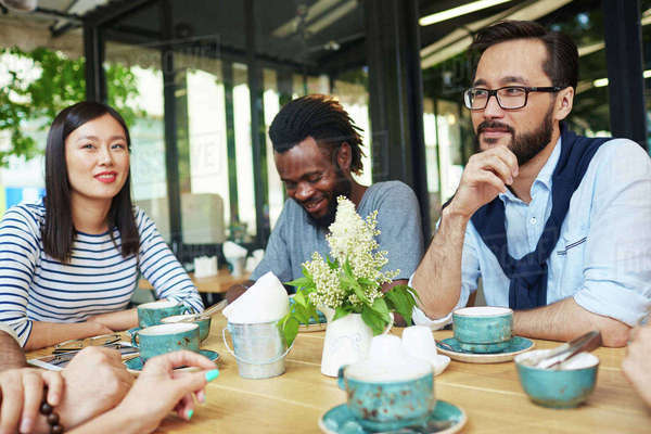 Young people drinking coffee at coffeeshop outdoors - Stock Photo ...