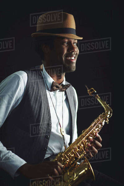 Happy young jazzman with sax - Royalty-free Stock Photo | Dissolve