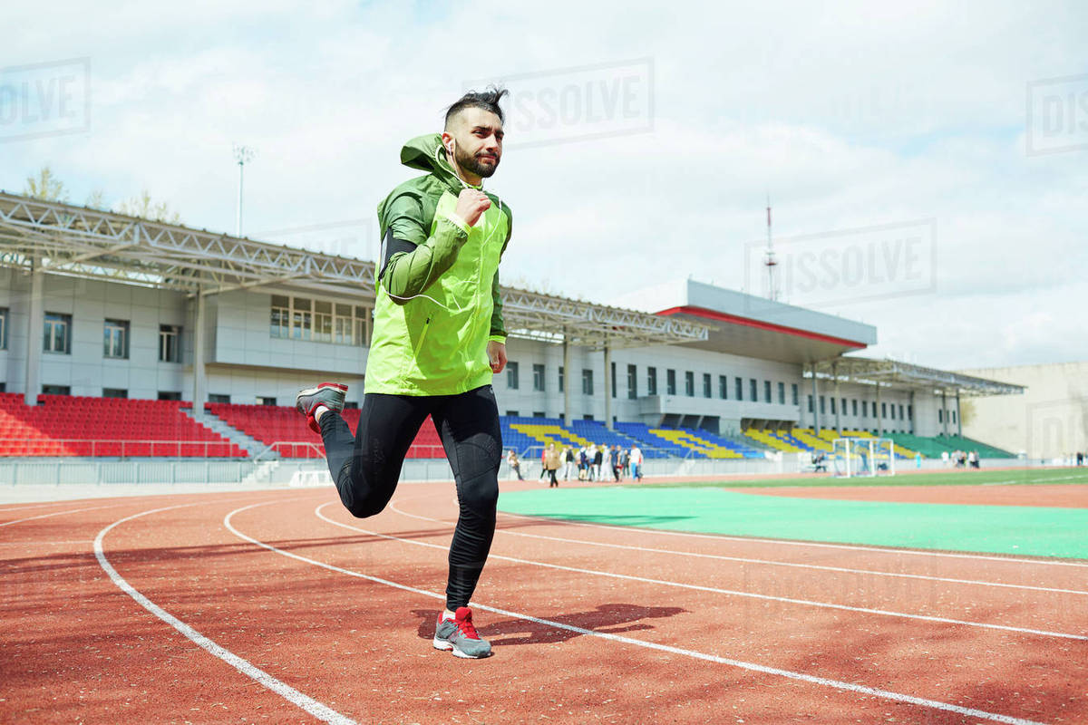 Active man jogging around race track in the morning - Royalty-free ...