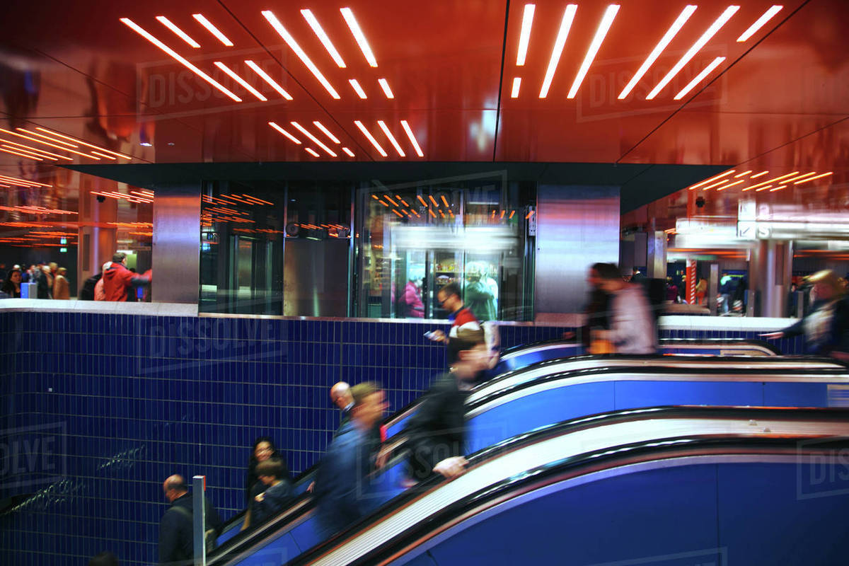 Crowd of hurrying people acsending and descending by escalator ...