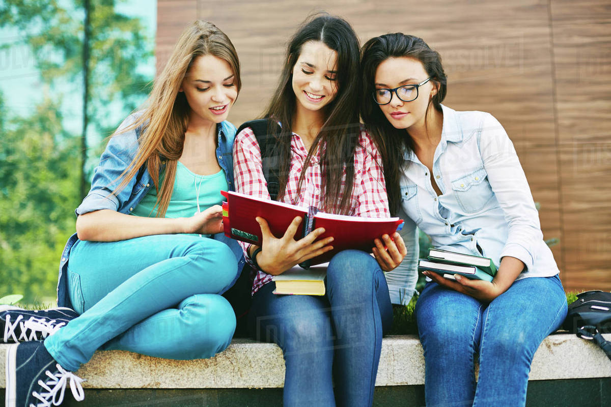 Modern college students reading outdoors - Royalty-free Stock Photo ...