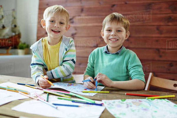 Adorable boys coloring pictures with highlighters at leisure - Royalty ...