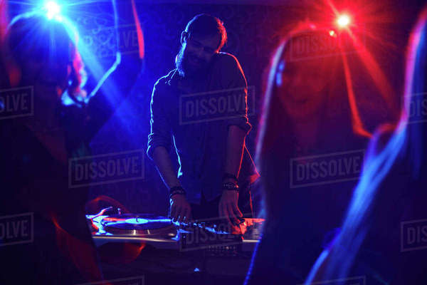 DJ at club with people dancing in front - Royalty-free Stock Photo ...