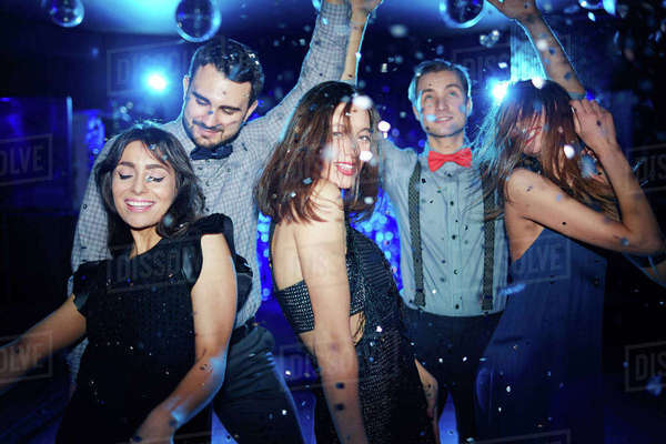 Posh girls and their boyfriends dancing in night club - Royalty-free ...