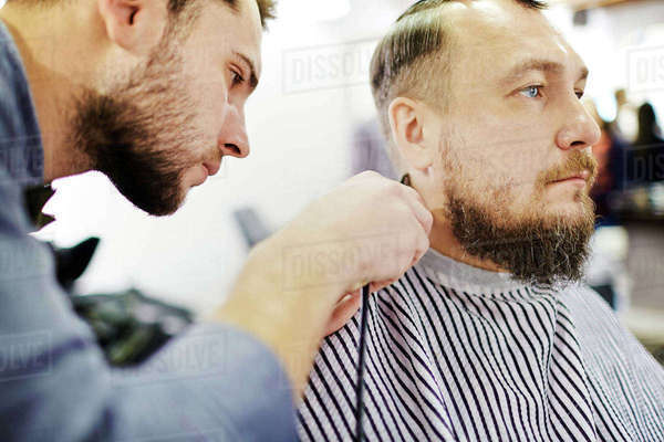 Barber shaving back of head of a customer - Royalty-free Stock Photo ...