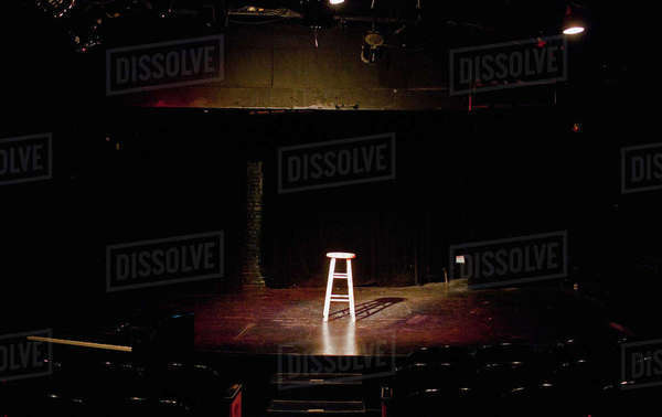 An empty stool spot lit on a stage - Royalty-free Stock Photo | Dissolve