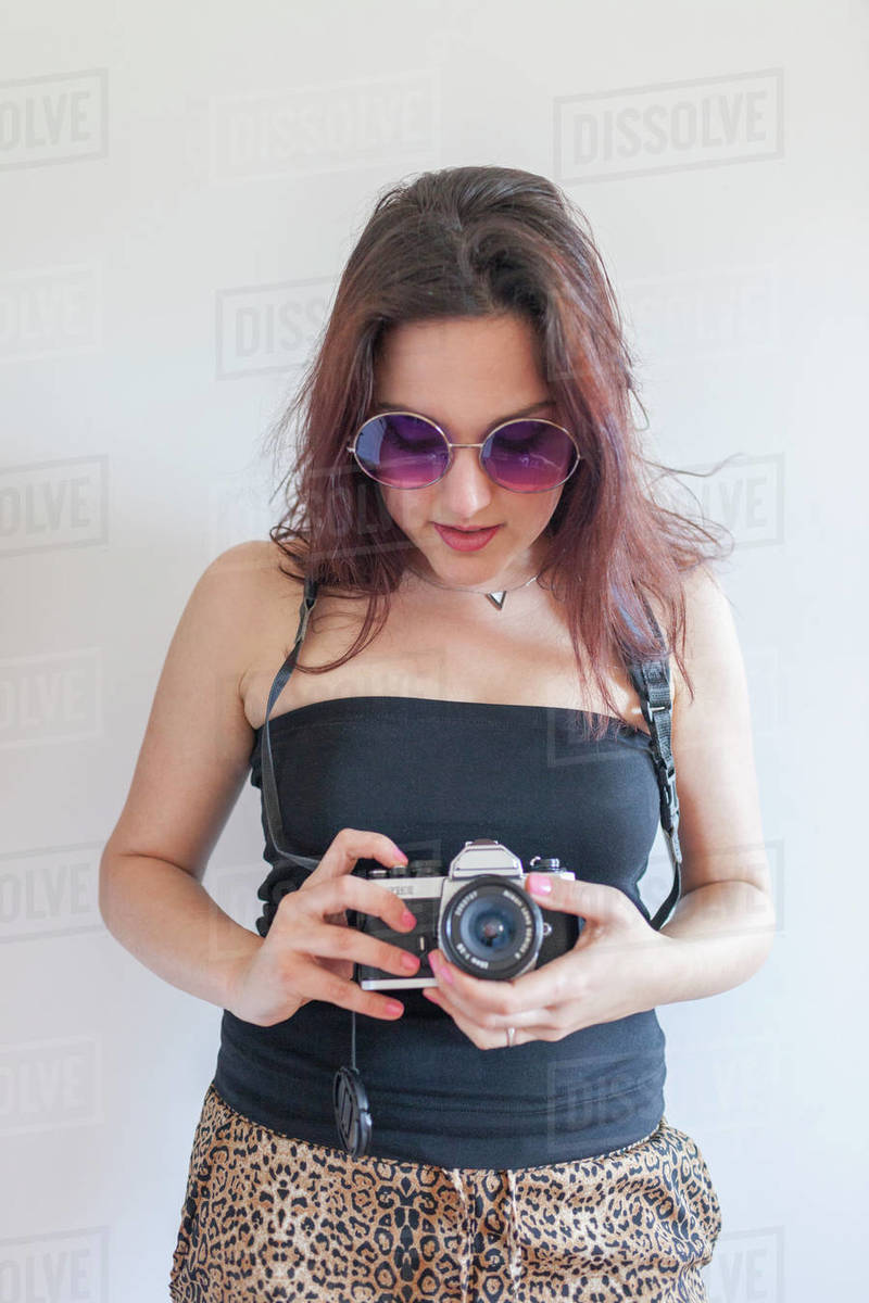 Portrait of a young woman with a camera - Royalty-free Stock Photo ...