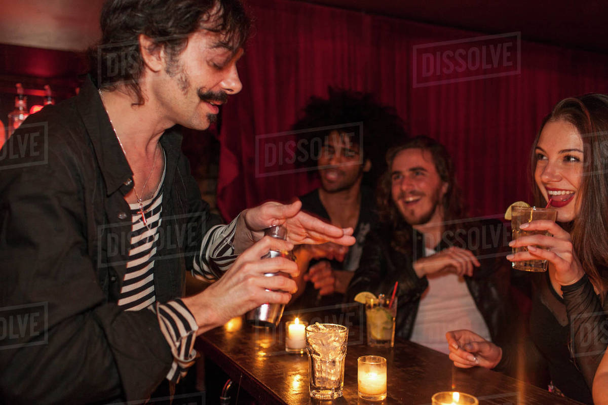Bartender serving drinks at a nightclub - Stock Photo - Dissolve