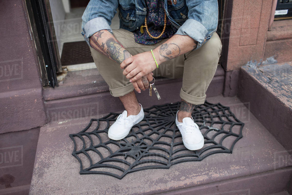 A young man sitting on a stoop - Royalty-free Stock Photo | Dissolve