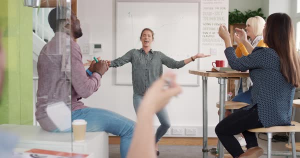 Crazy happy businessman dancing doing victory dance in team meeting ...